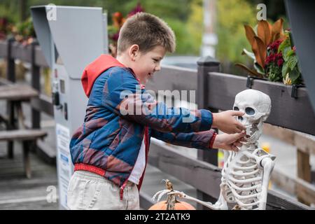 Smiling boy touching teeth you skeleton during Halloween teeth Stock ...