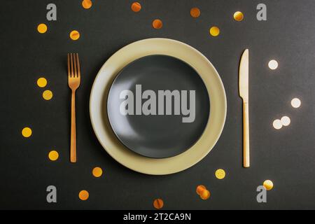 Stylish table setting on black background Stock Photo - Alamy