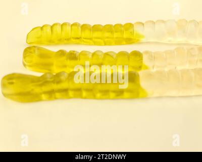 gummy worms lie on a white matte background. bright, mouth-watering ...