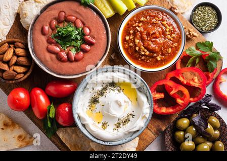 Selection of arabic mezze food - foul, labneh yogurt, muhamara dip on ...