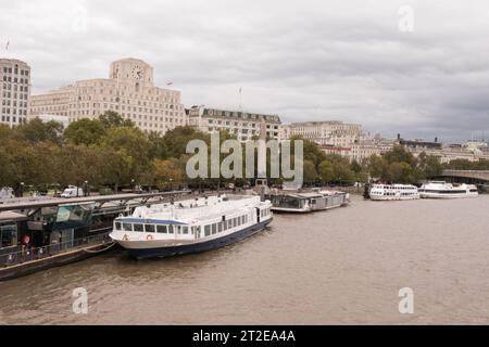 Pleasure cruisers at Embankment Pier on the River Thames, next to Shell ...