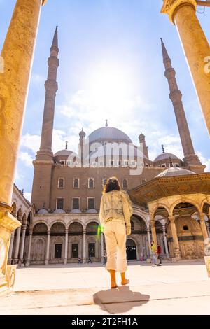A young tourist walking in the inner courtyard of the Alabaster Mosque ...