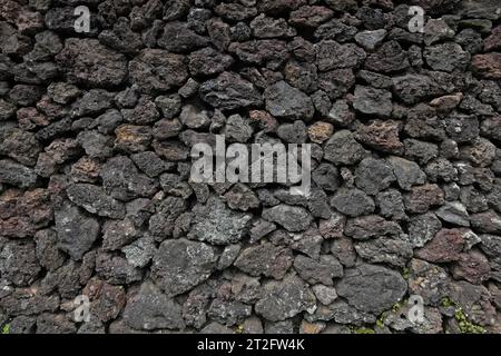 view to stone wall made of volcanic stones, Oia, Santorini, Greece ...