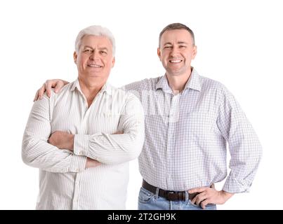 Mature brothers hugging on white background Stock Photo - Alamy