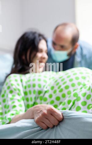 Pregnant woman pushing and screaming during childbirth, receiving ...