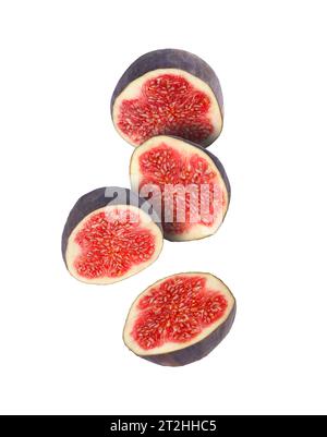 Halved fresh figs falling on white background Stock Photo - Alamy