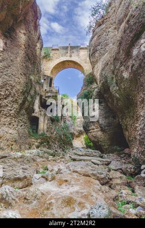 stone bridge over a cliff with a dry riverbed running underneath. in ...