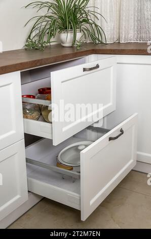 White drawers in the kitchen set. Open furniture drawers Stock Photo ...