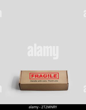 A rectangular cardboard box. Monochrome light background. An adhesive ...