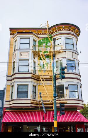 Chez Maman restaurant below yellow apartment building with bay windows ...
