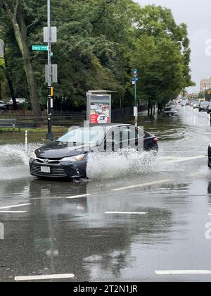 Cars float on water, flooding streets. spraying water of a car moving ...