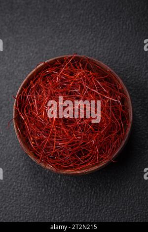 Red thin hot chili threads on a dark background. For decorating Asian ...
