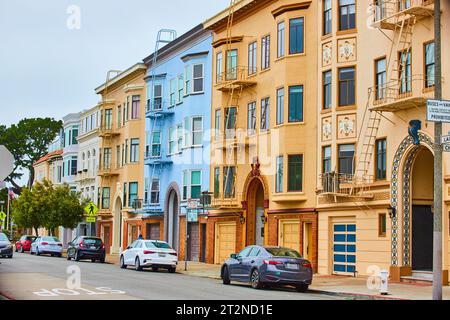 Tightly compact buildings with and fire escape ladders down sides of ...