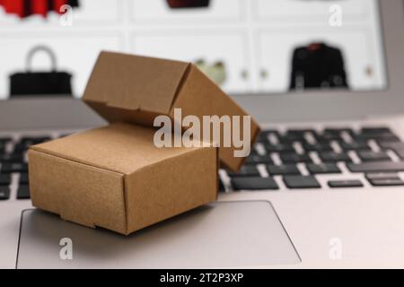 Mini boxes on laptop, closeup. Online store Stock Photo - Alamy