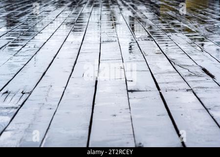 wet boards of a wooden sidewalk during the rain Stock Photo - Alamy