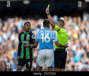 Rodri of Manchester City receives a yellow card from referee Chris ...