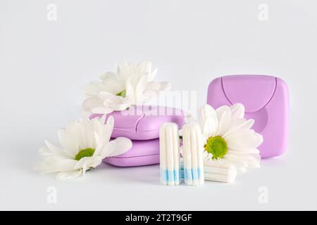 Tampons storage boxes and chamomile flowers on white background Stock ...