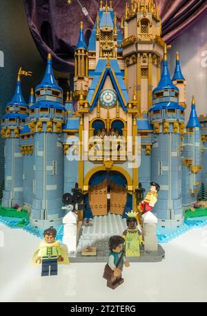 Lego store window display with colorful characters and people walking ...