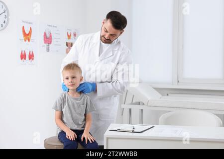 Endocrinologist examining boy's thyroid gland at hospital Stock Photo ...