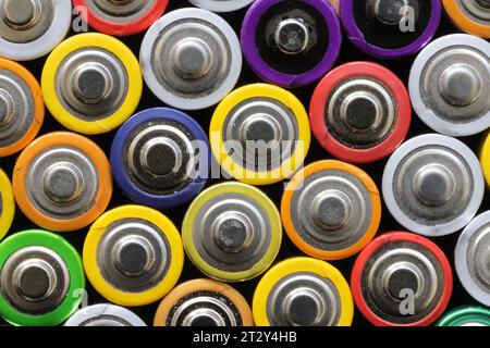 many round batteries and one red battery Stock Photo - Alamy