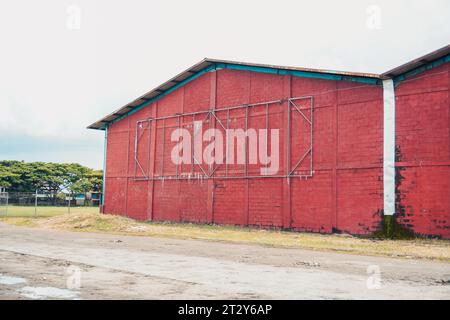 Vibrant warehouse backdrop with red wall and banner frame Stock Photo ...