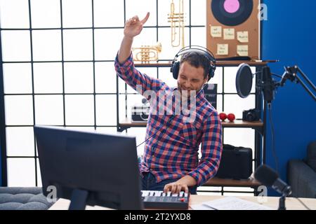 Young man musician having dj session at music studio Stock Photo - Alamy