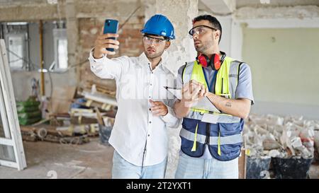 Two construction workers are having a serious discussion, close up ...