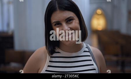 Young beautiful hispanic woman visiting church at Augustinian Church in ...