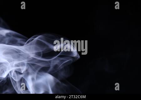 Cold silver smoke on a dark background, colourful abstract, white fog ...