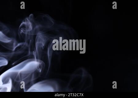 Cold silver smoke on a dark background, colourful abstract, white fog ...
