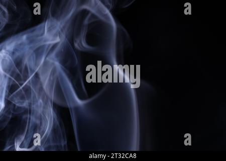 Cold silver smoke on a dark background, colourful abstract, white fog ...