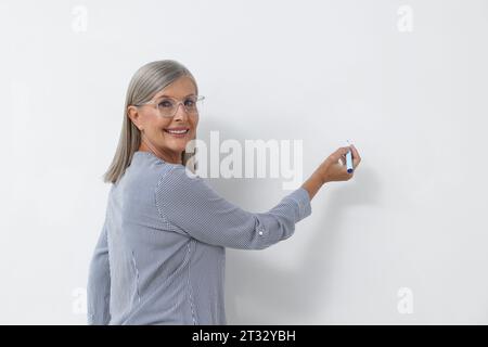 Portrait of professor explaining something at whiteboard indoors Stock ...