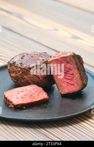 sliced medium fillet mignon steak on wood board Stock Photo - Alamy