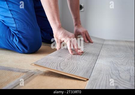 Man laying laminate flooring in construction concept Stock Photo - Alamy