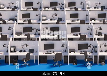 High-angle view of cubicles with tables, chairs, and computers in a modern office building. A ...