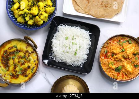 Indian vegetarian Thali or platter includes Aloo ki sabji, dal rice ...