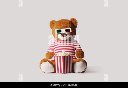 Cute teddy bear watching movies and eating popcorn Stock Photo - Alamy