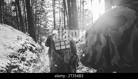 man in black costume with submachine gun (SMG) isolated on white ...