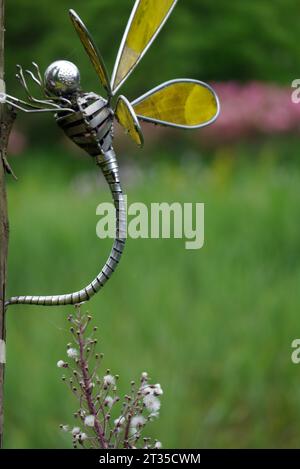Yellow Metal Dragonfly Sculpture on a Post by the Magnolia Lake at The ...