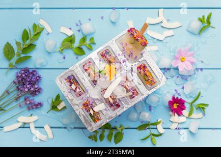Homemade lemonade ice pops with herbs, edible flowers and coconut ...
