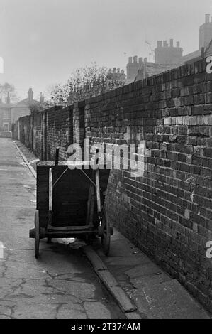 Wooden handcart parked in a back lane between houses on Berkley Street ...