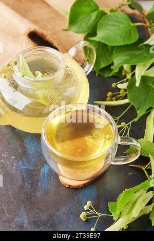 Aesthetic herbal linden tea in teapot with cup of tea. Wheat, leaves ...
