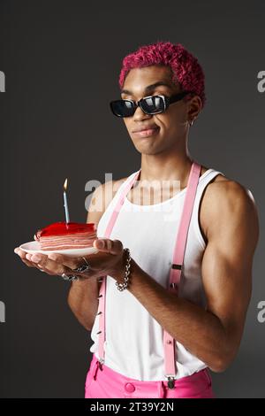 Handsome young man with burning candle in darkness Stock Photo - Alamy