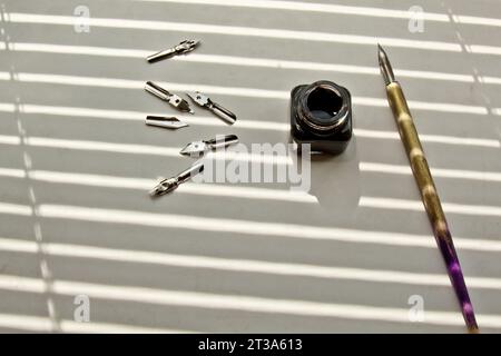 Inkpot with metal tips for the ink pen on a white background in solar ...