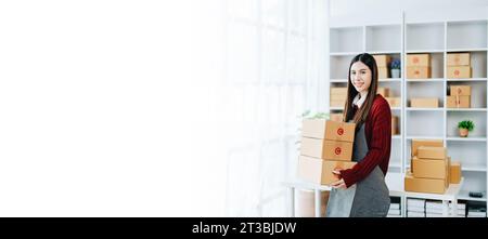 Asian female business owner handles delivery of orders to customers ...