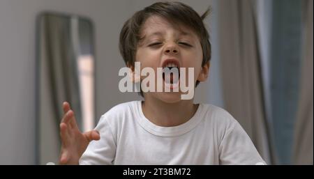 Upset child emotion in slow-motion. Close-up of angry little boy ...