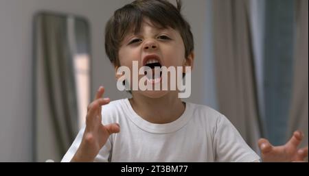 Upset child emotion in slow-motion. Close-up of angry little boy ...