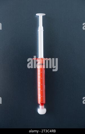 one medical syringe on a dark gray background with reflection Stock ...