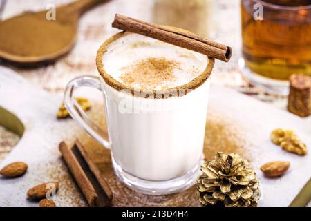glass of eggnog prepared with liqueur, cinnamon, refined sugar, almond ...