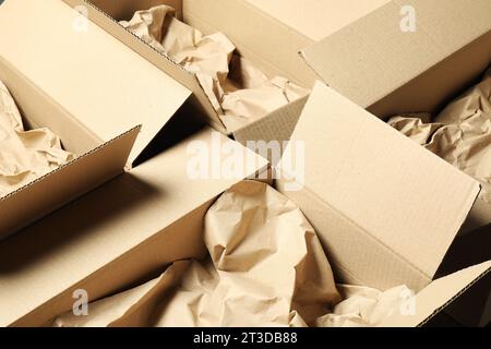 Open cardboard boxes with crumpled paper, top view. Packaging goods ...